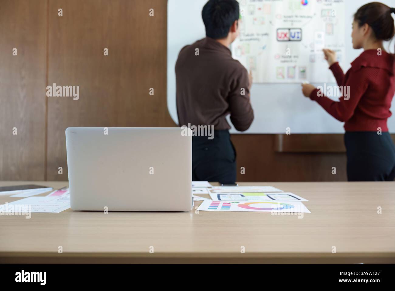 Design Planning Session. Team strategizes on UX UI design with laptops ...