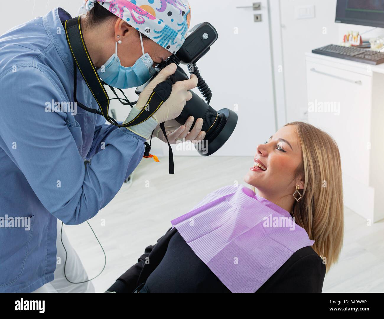 Dentist takes pictures of a young woman's teeth using a professional ...