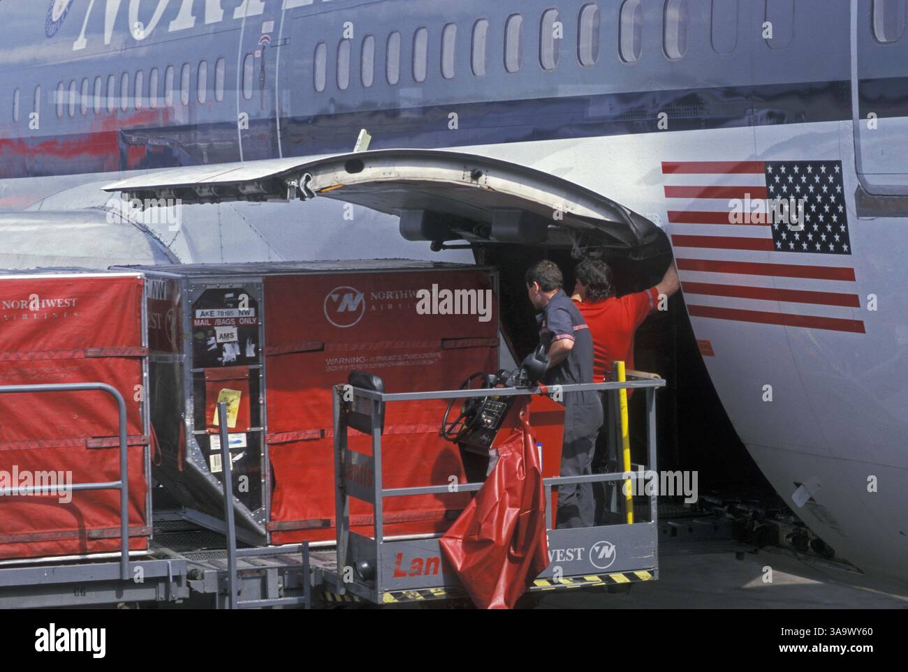 Mar 30, 1998; Romulus, MI, USA; Workers at Detroit Metro airport load ...