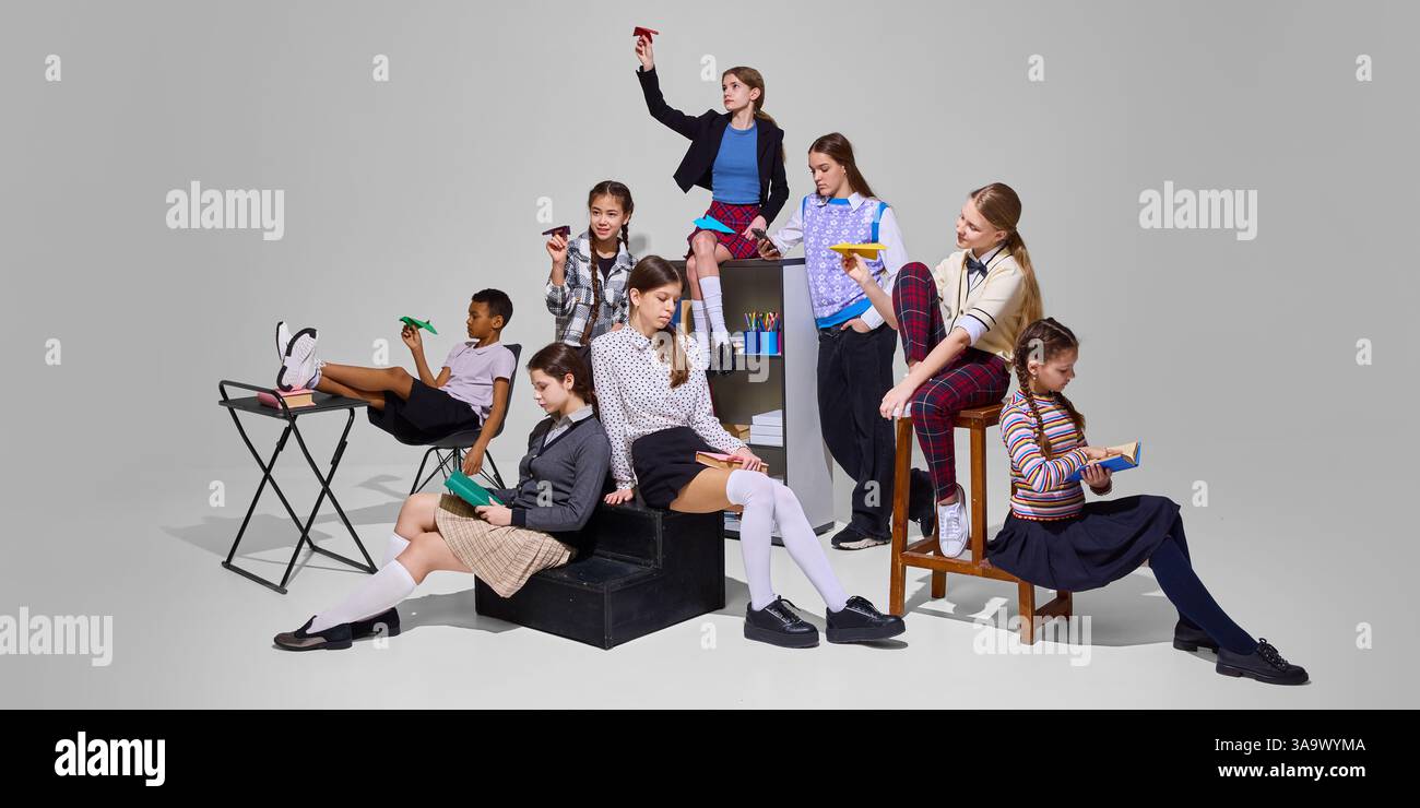 Group of students in varied poses, some with paper planes, others ...