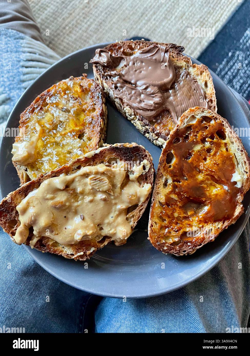 four pieces of toast with for different toppings- nutella marmite ...