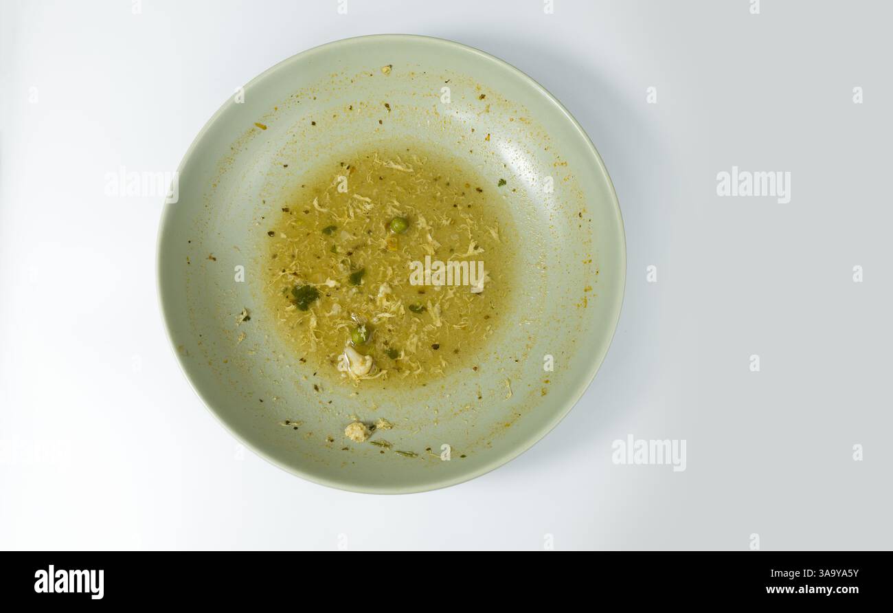 Dirty food waste in a plate on white background Stock Photo - Alamy