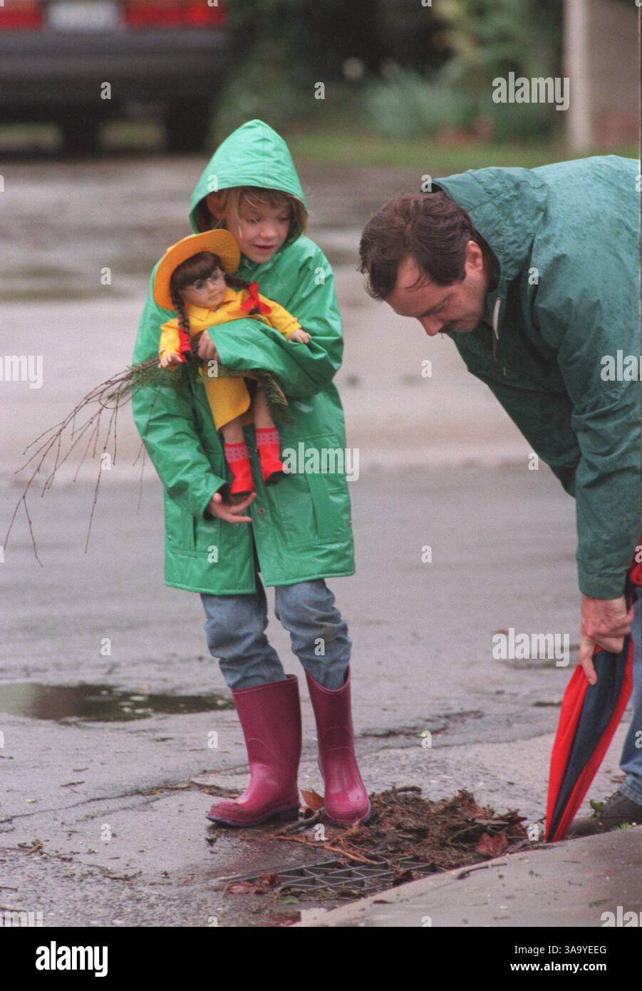 Danielle Dana (left) carring her doll ''Molly'' watches her father ...