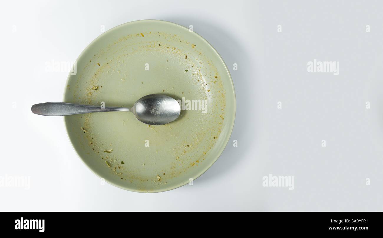 Dirty food waste in a plate on white background Stock Photo - Alamy