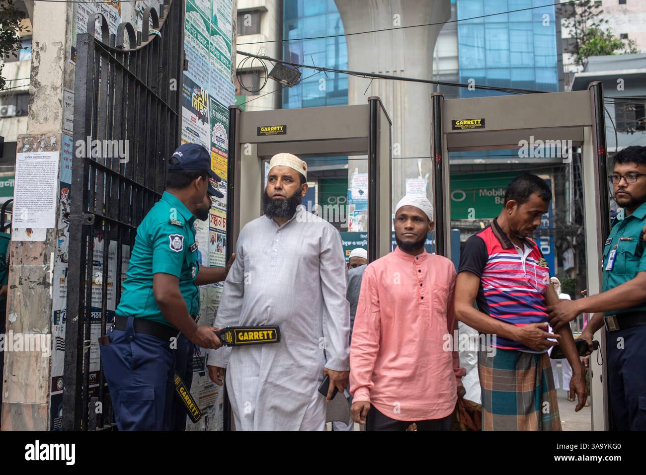 People walk through a security check post as they arrive to offer ...