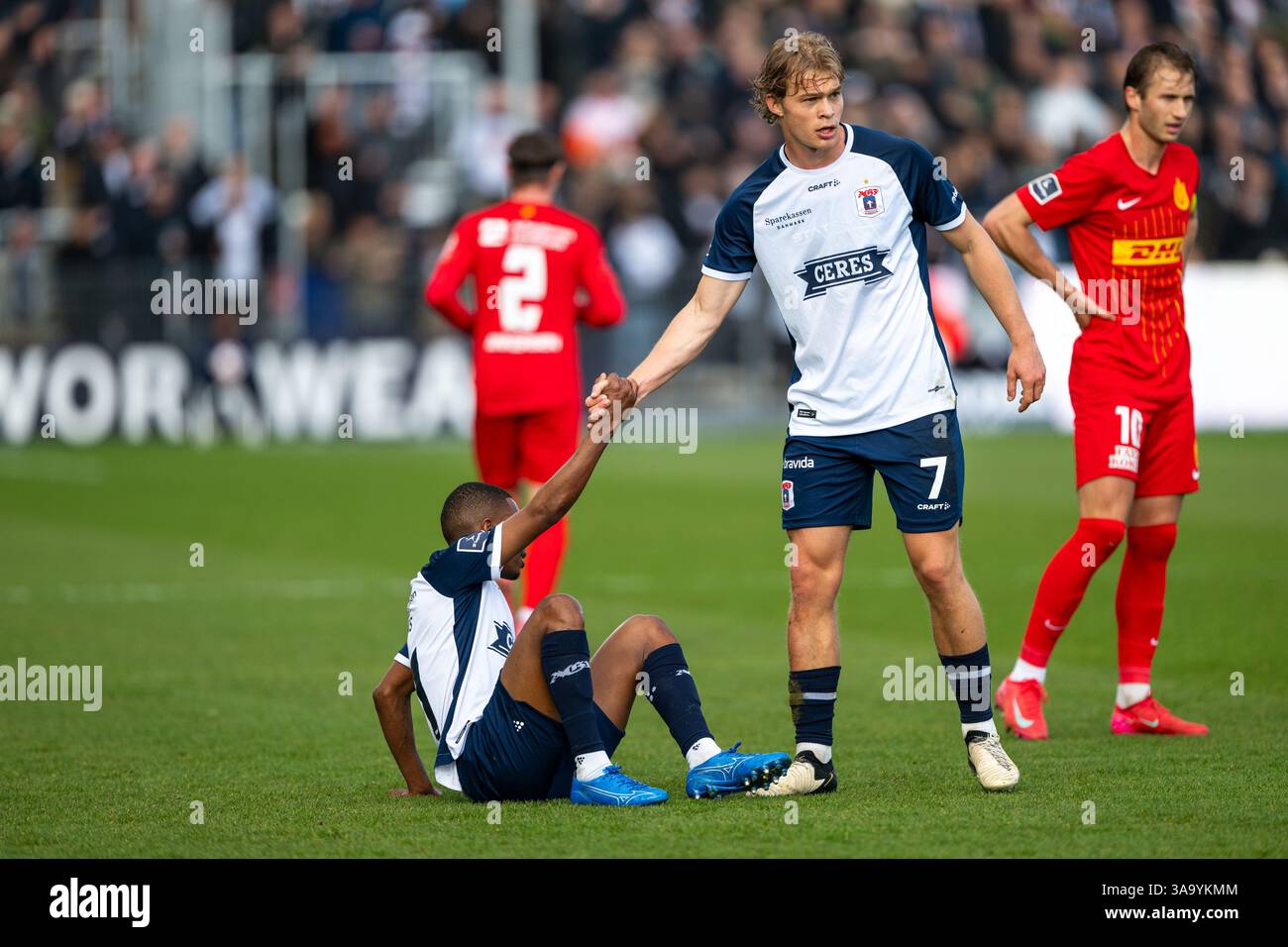 Aarhus, Denmark. 30th Mar, 2025. Mads Emil Madsen (7) of AGF gives a ...