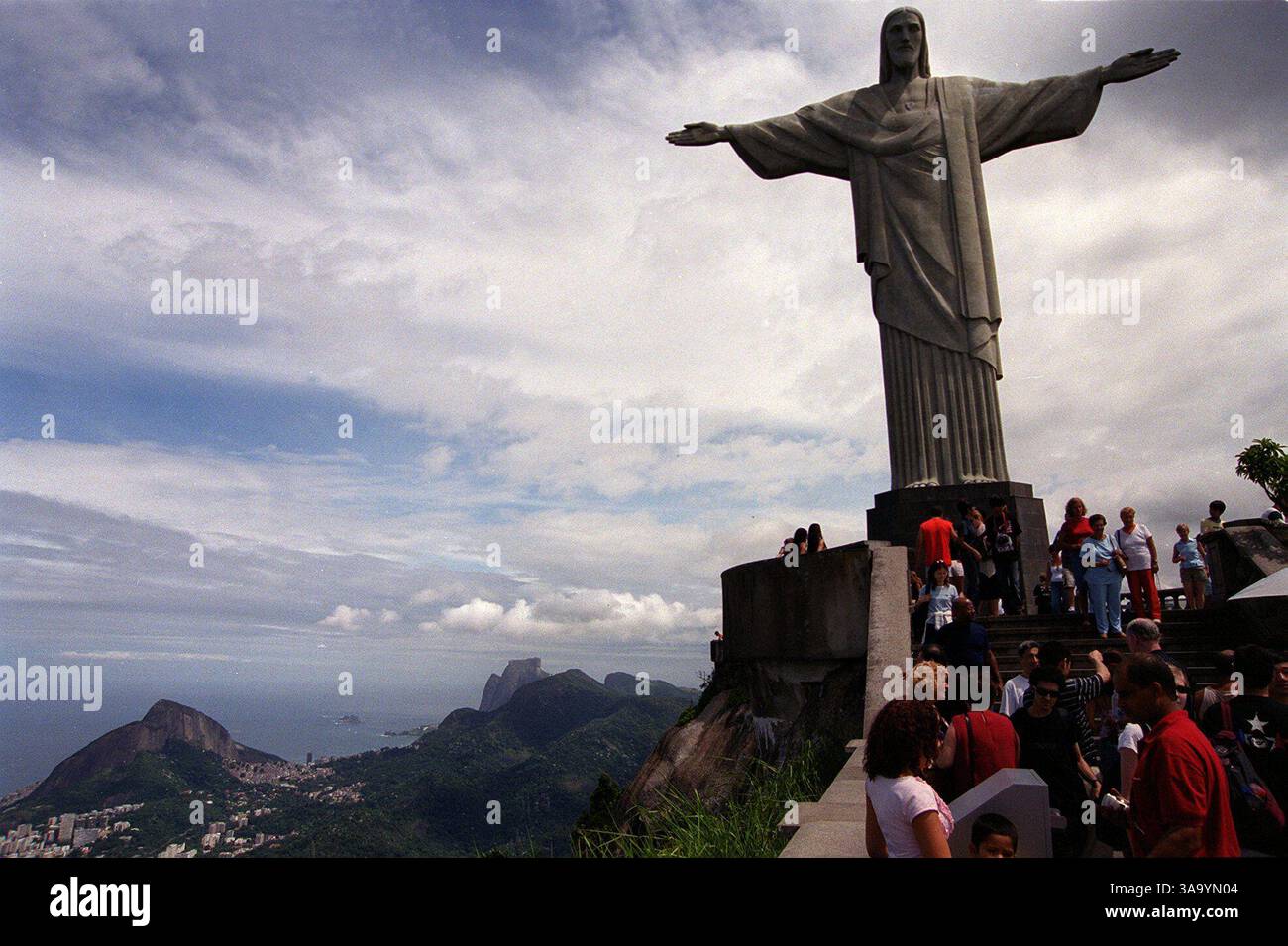 Tourists throng around the base of the 100-foot statue of Christ the ...