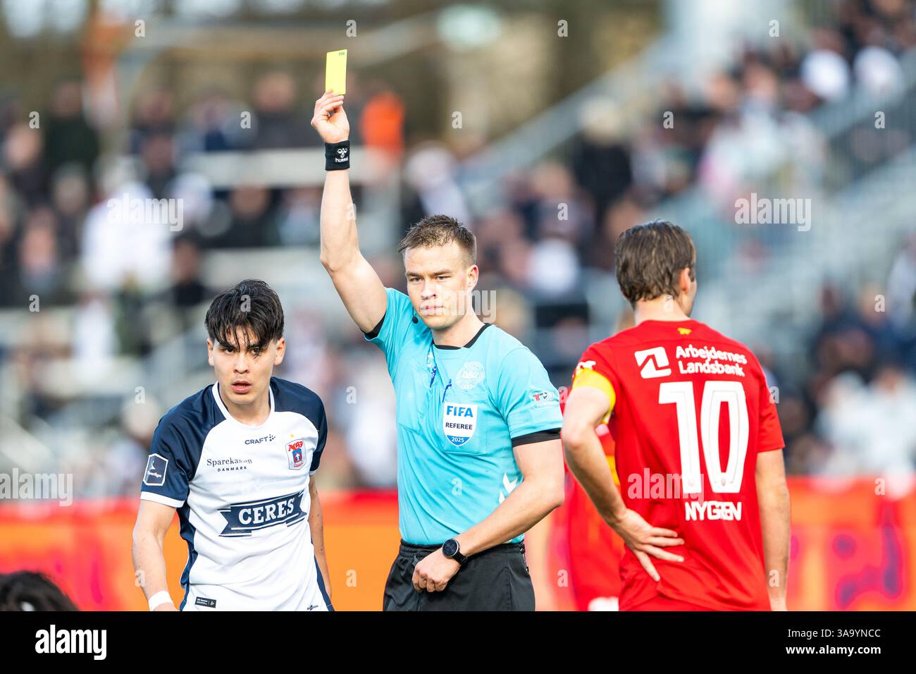 Aarhus, Denmark. 30th Mar, 2025. Referee Jacob Karlsen books Eric Kahl ...