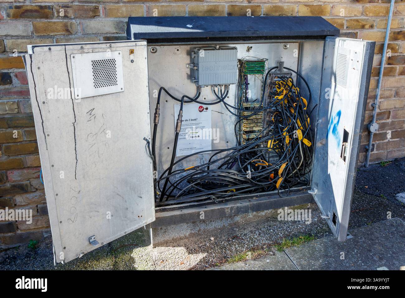 A Virgin Media telecoms and broadband cabinet with its doors open ...