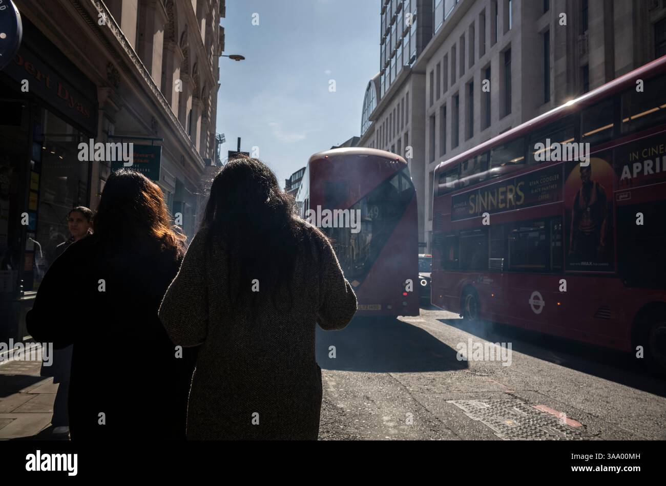 A diesel double-decker bus distributing polluting toxic fumes as it ...