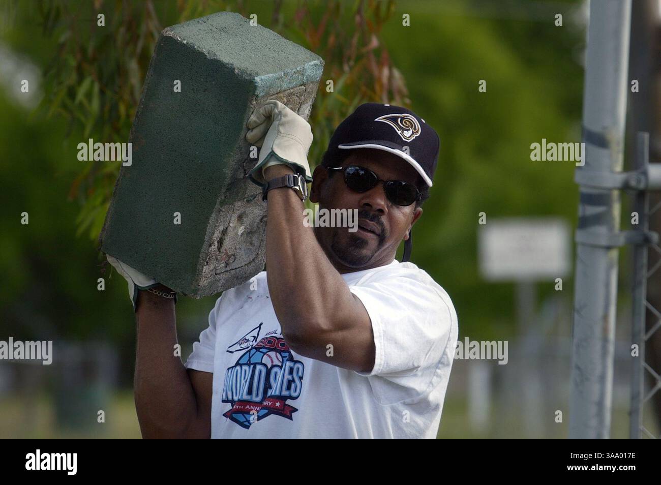 Mark Cole, 37, carries a concrete block as he and other former players ...