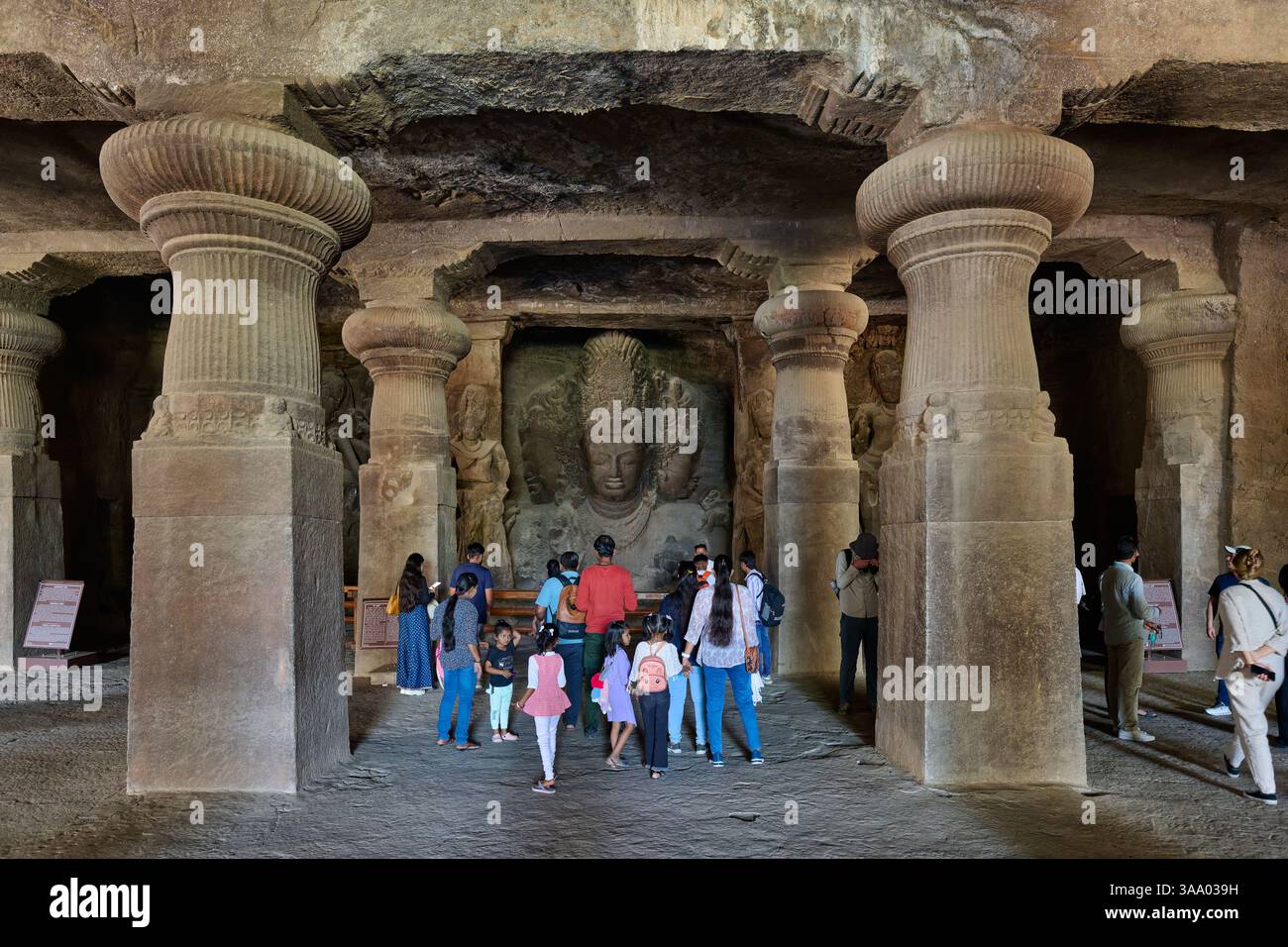 tourists in front of the Eternal Shiva, the Sadashiva, Elephanta caves ...