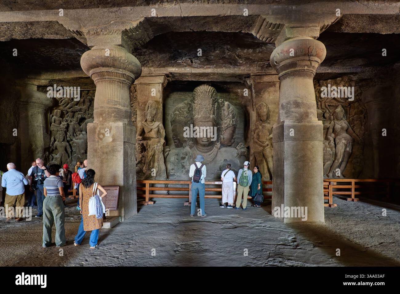 tourists in front of the Eternal Shiva, the Sadashiva, Elephanta caves ...