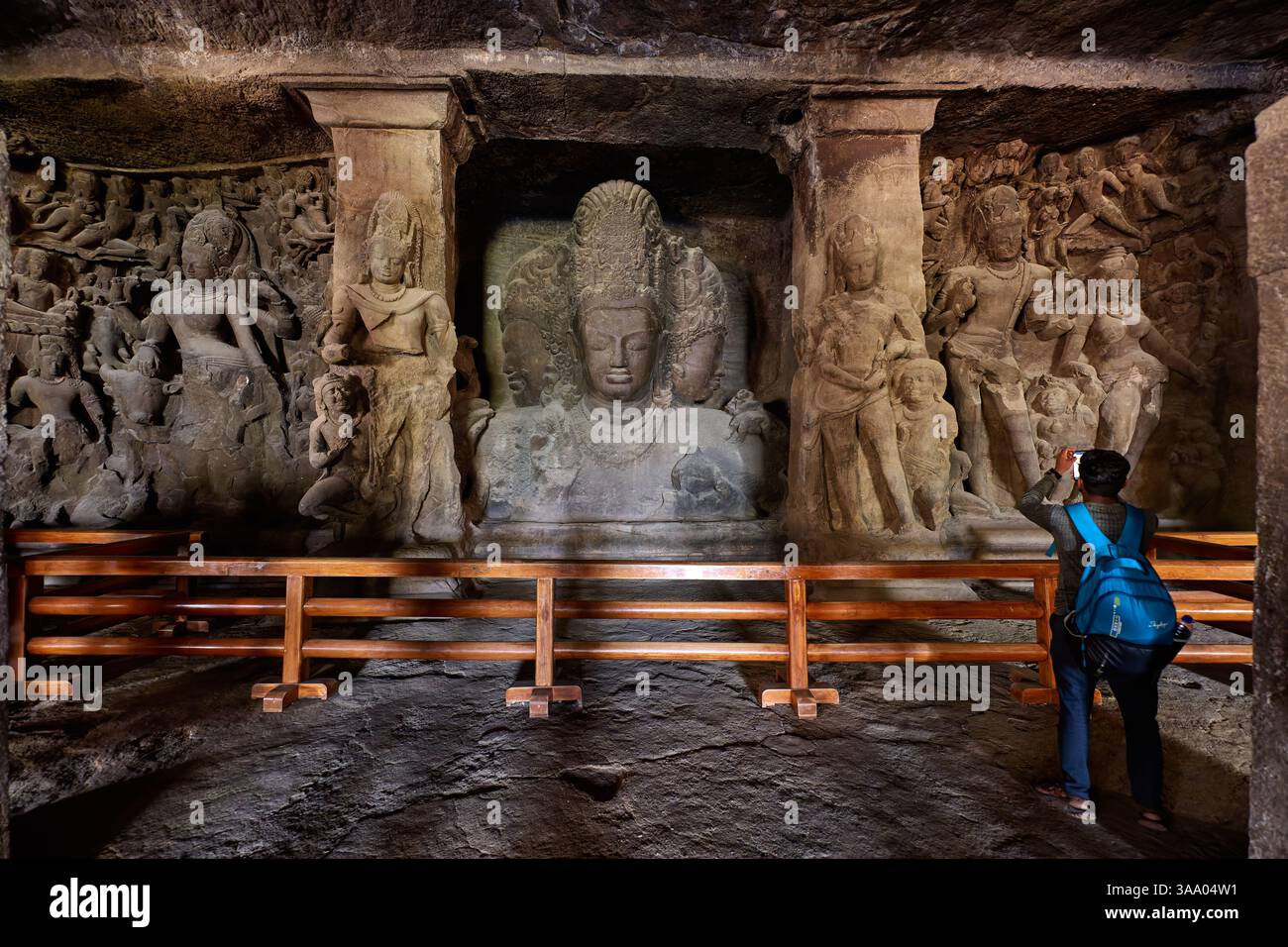tourist in front of the Eternal Shiva, the Sadashiva, Elephanta caves ...