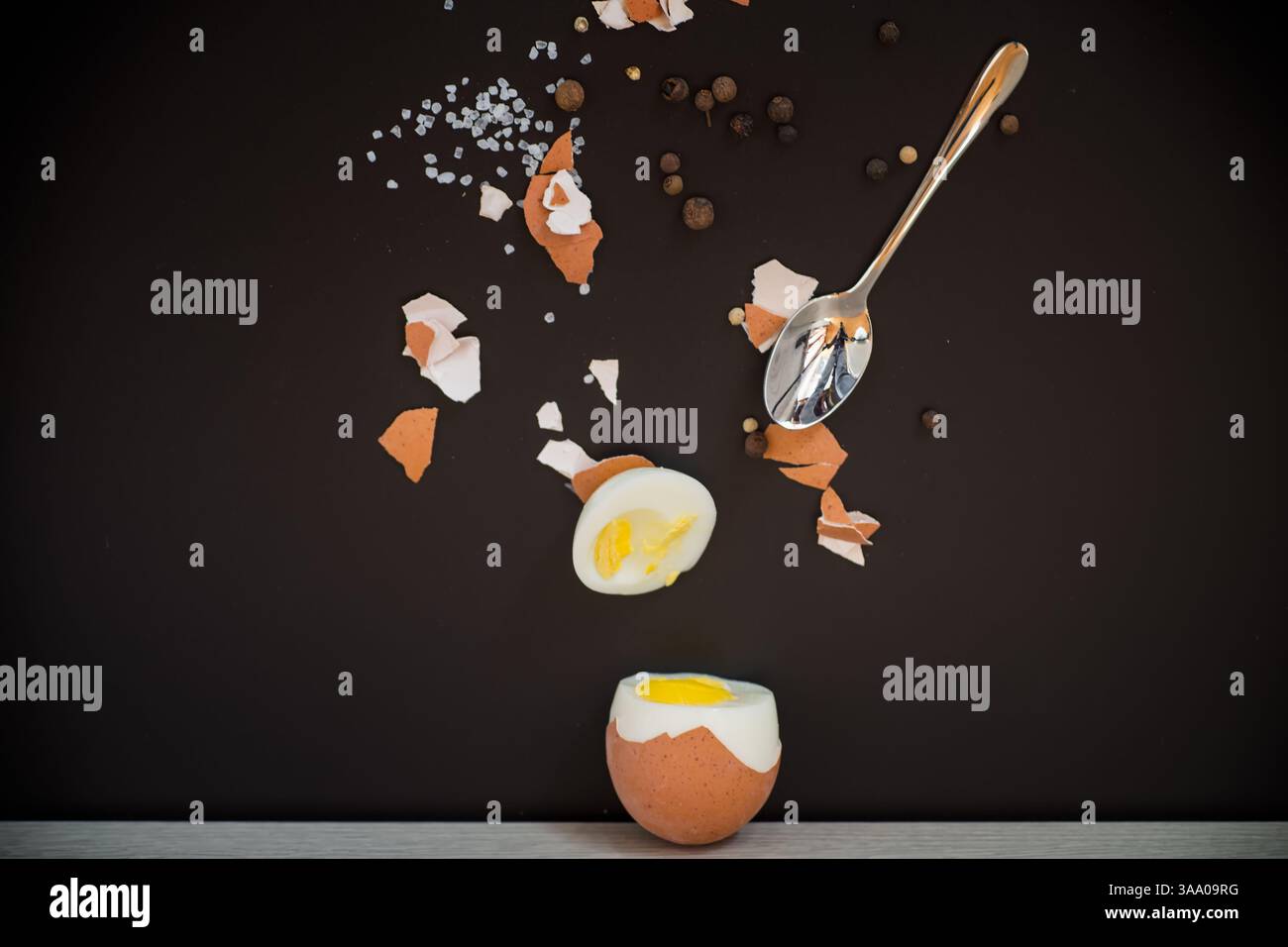 Boiled egg with spices and shell on black background Stock Photo - Alamy