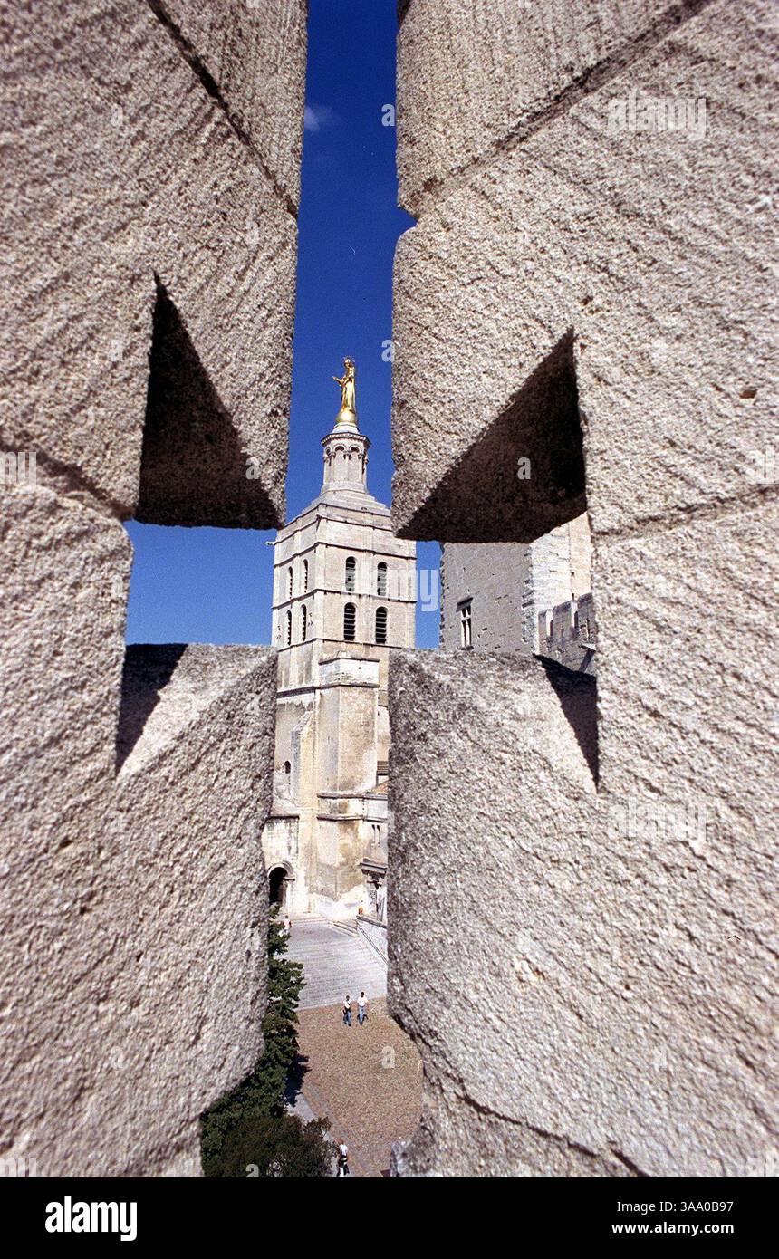 A church tower is seen through a defensive slit shaped like a Gothic ...