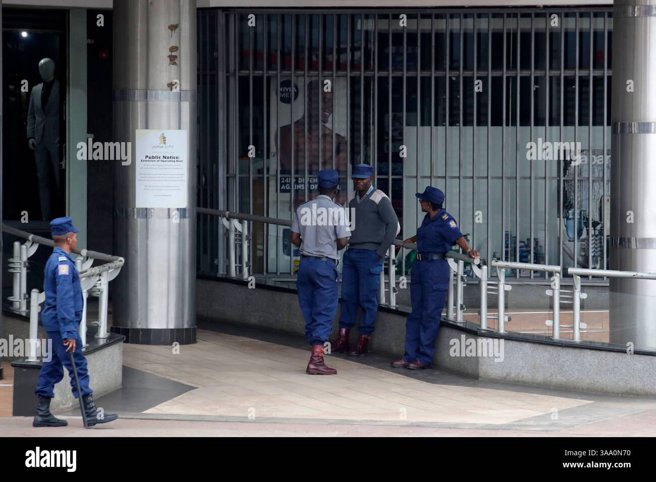 Riot police officers gather on a deserted street in downtown Harare ...