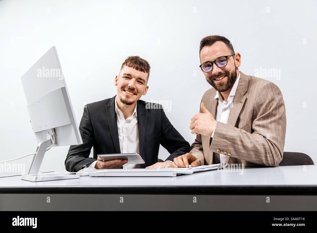 Two business men are brainstorming in a bright office, working and ...