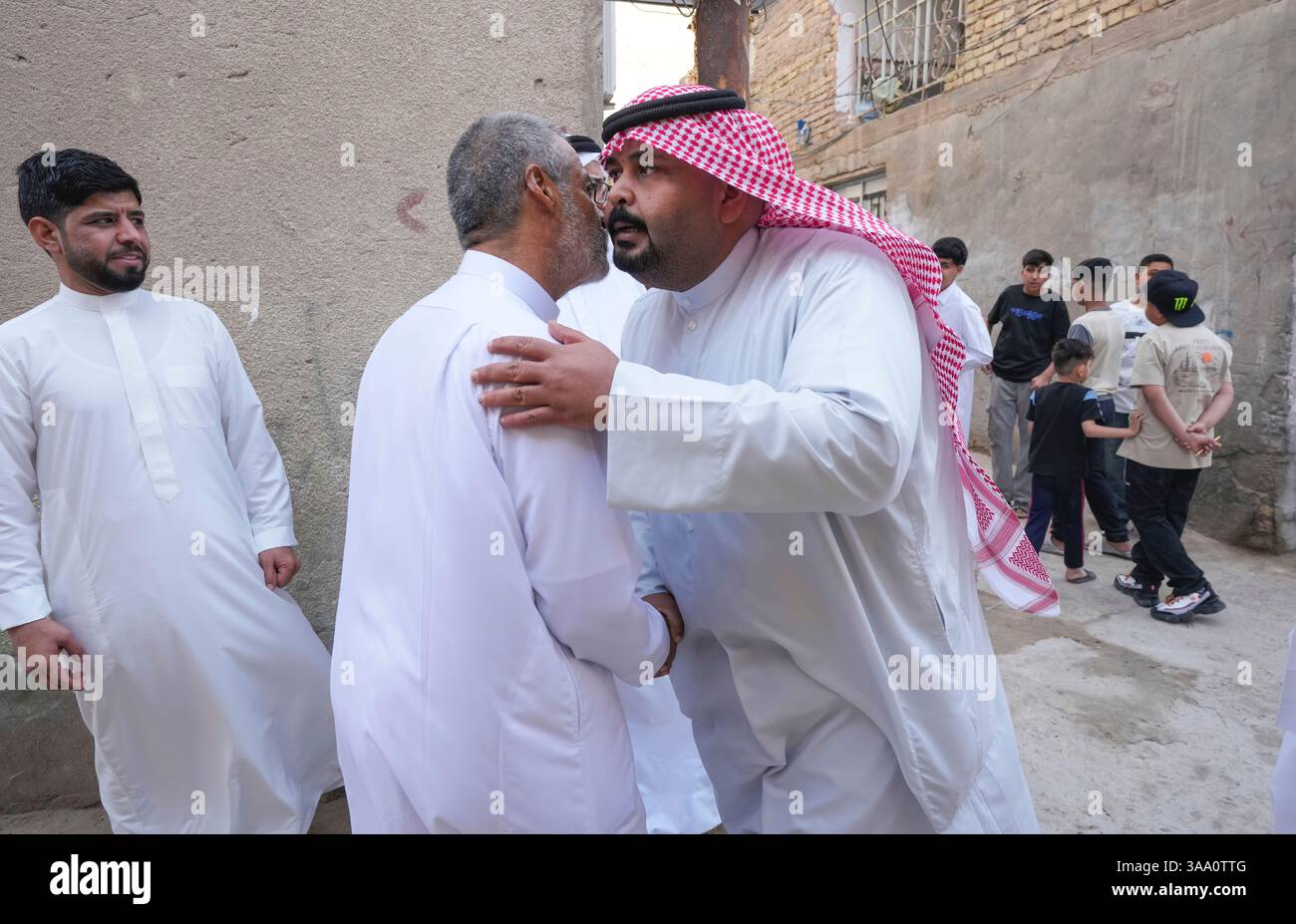 Iraqi Muslims greet each other after prayers on the first day of Eid Al ...