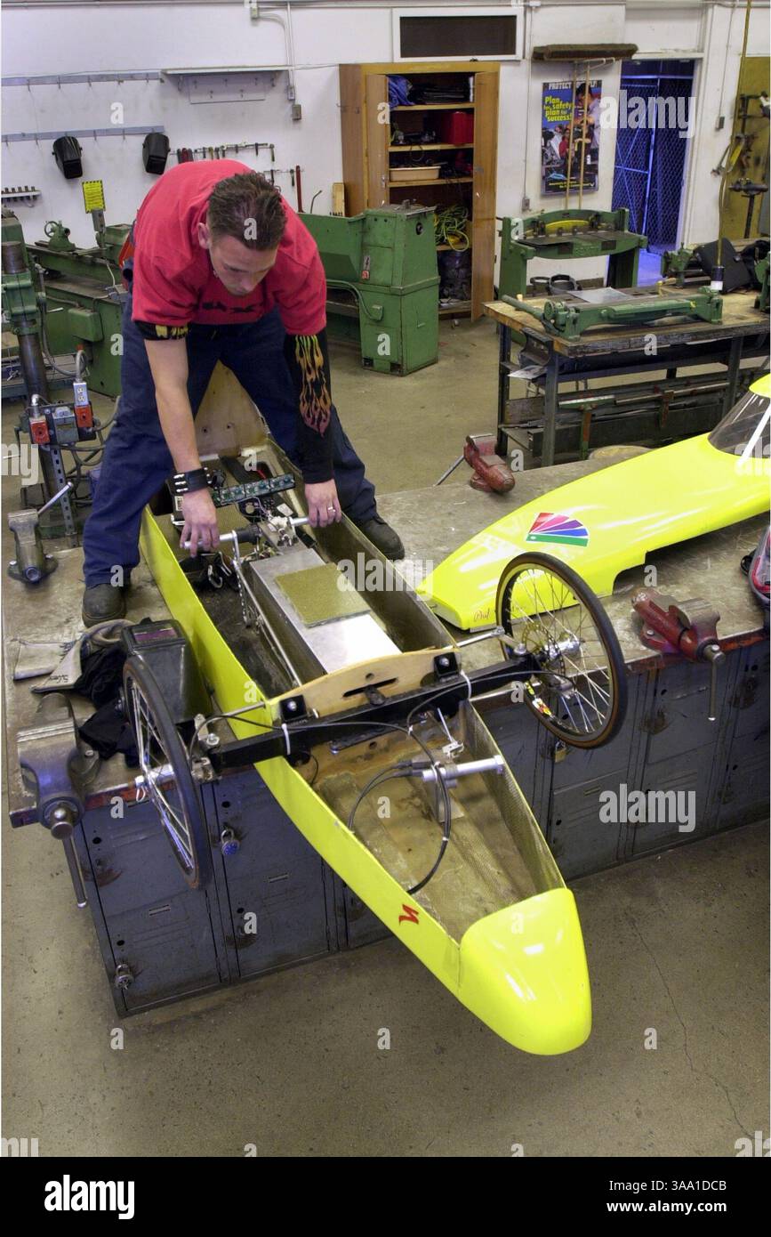 Stephen Geisel , a senior, checks the steering mechanism on an electric ...
