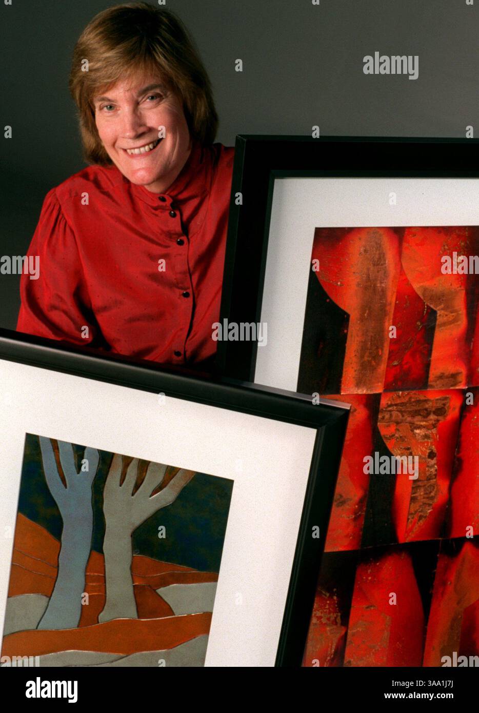 Susan Willoughby poses Wednesday February 27, 2002 with some of the art ...