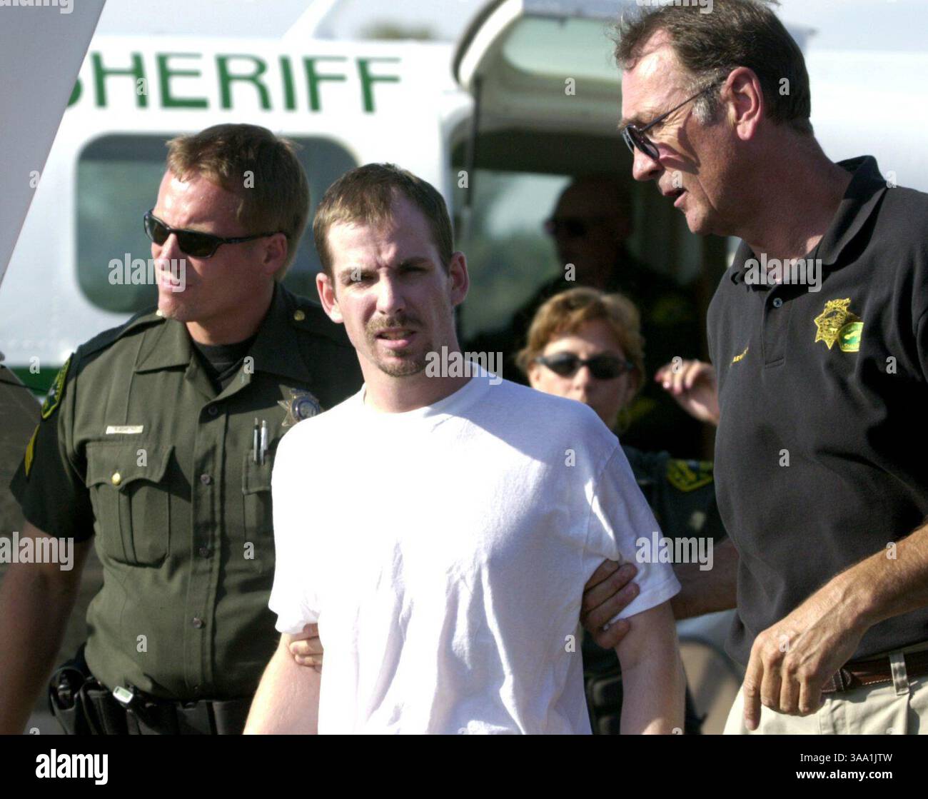Mitchell Crooks is escorted from a plane in Auburn, Friday evening ...
