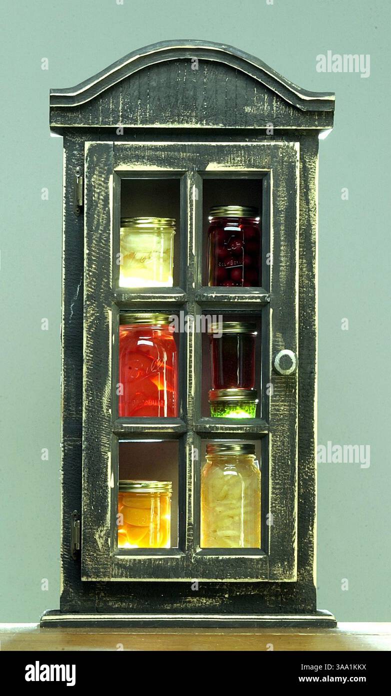 Light passes through preserved fruits, jams and jelly in this antique ...