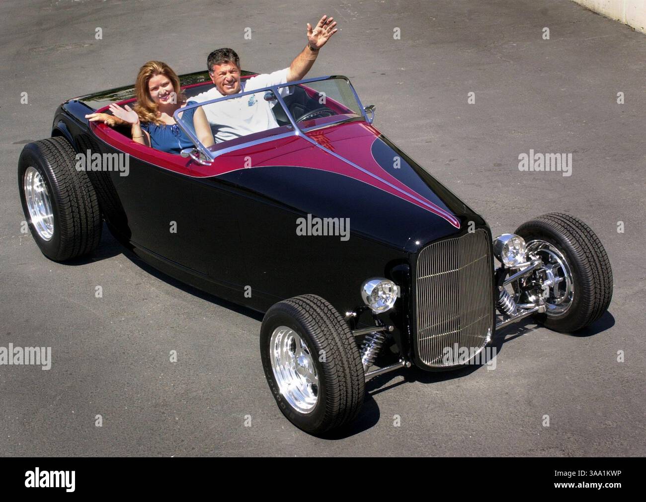 Stevi Sweeney and Joe Bevaqua wave from a 00,000 Muroc Roadster that ...