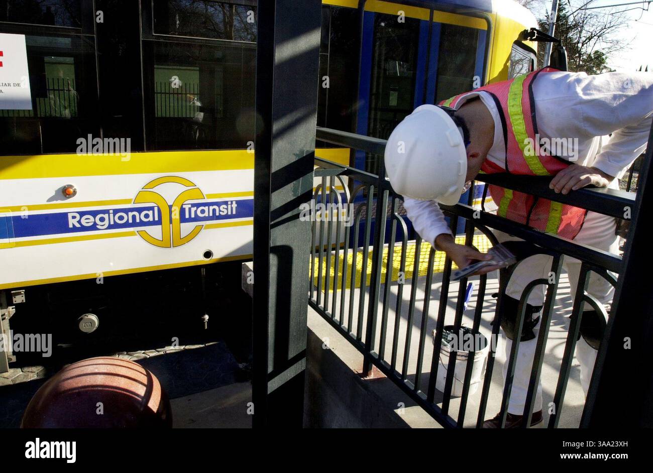 Geno Guerrero of Harriet Anderson Painting paints the railing of the ...