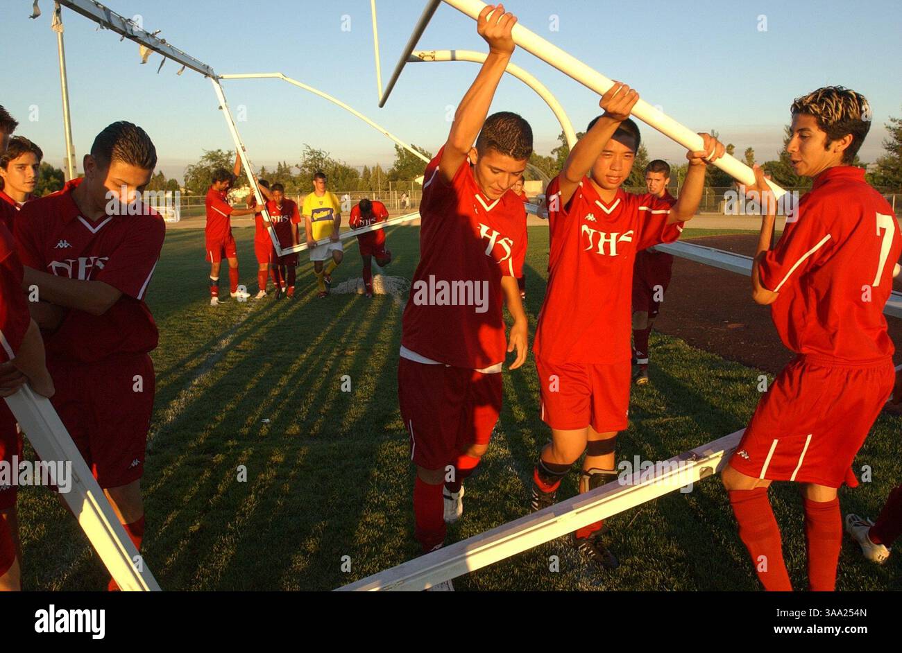 Soccer players set up a goal on the Natomas High School field. The ...
