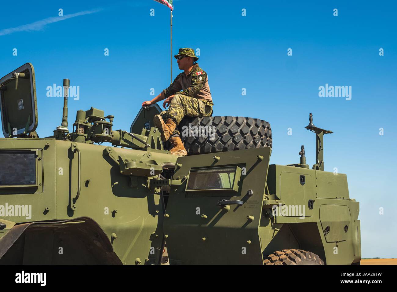 Armored Car with Canadian soldier on the training field. Canadian ...