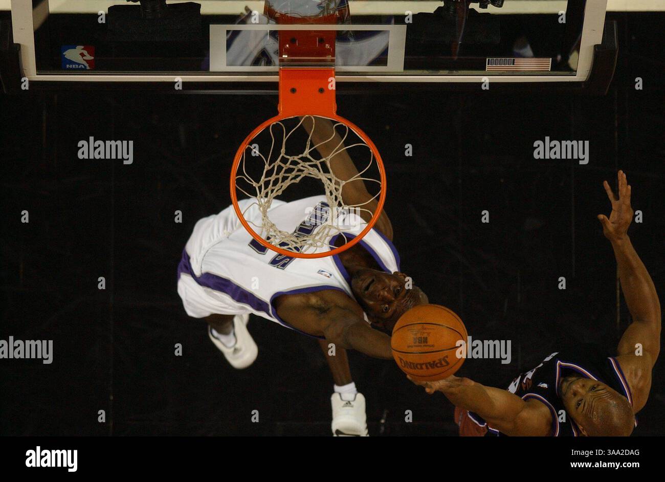 Kings Keon Clark goes high for a rebound in front of Jazz Karl Malone ...