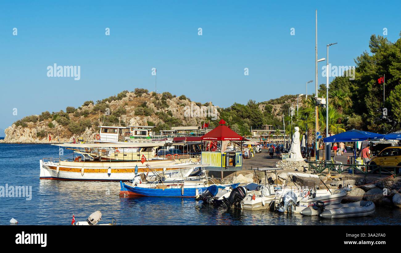 Ships and boats on pier next to promenade in village of Turunc, Turkey ...