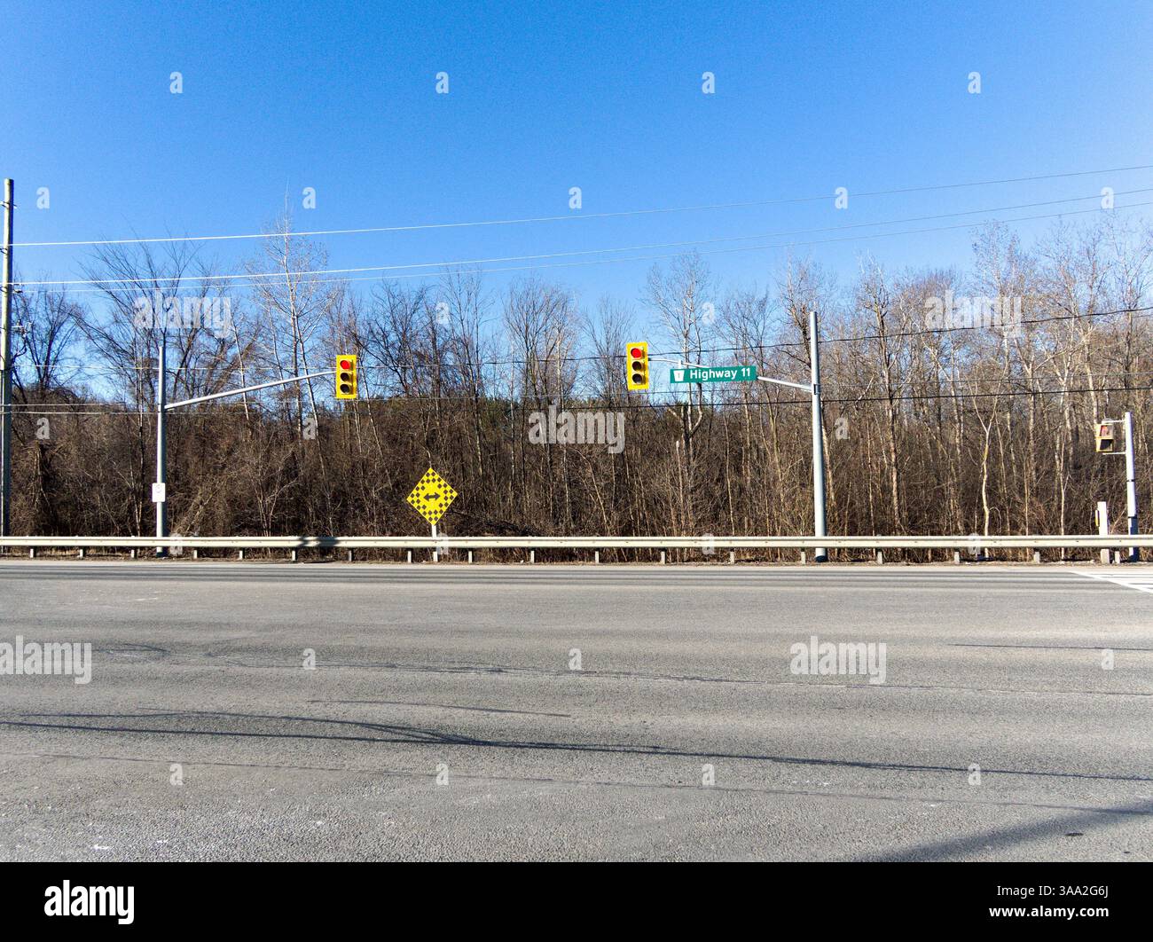 The image captures an intersection on Highway 11, featuring traffic ...