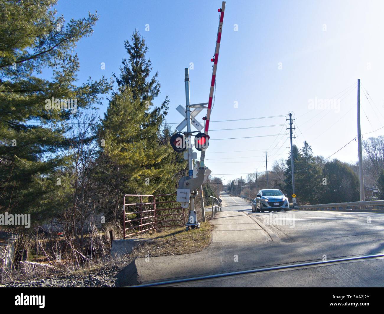 Railroad safety mechanism activated barrier lowered and red lights ...