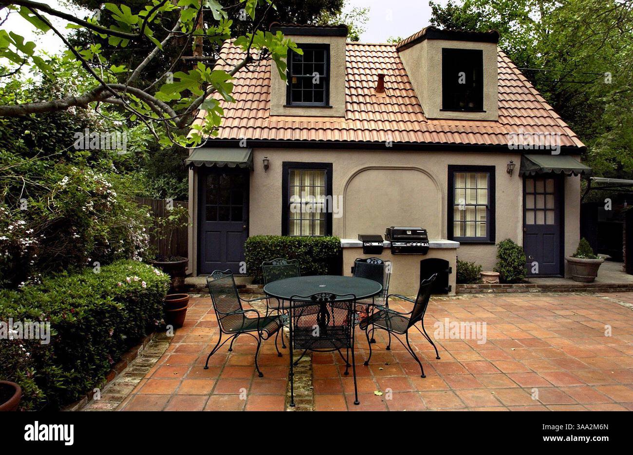 Backyard patio with built in barbecue are adjacent to carriage house ...