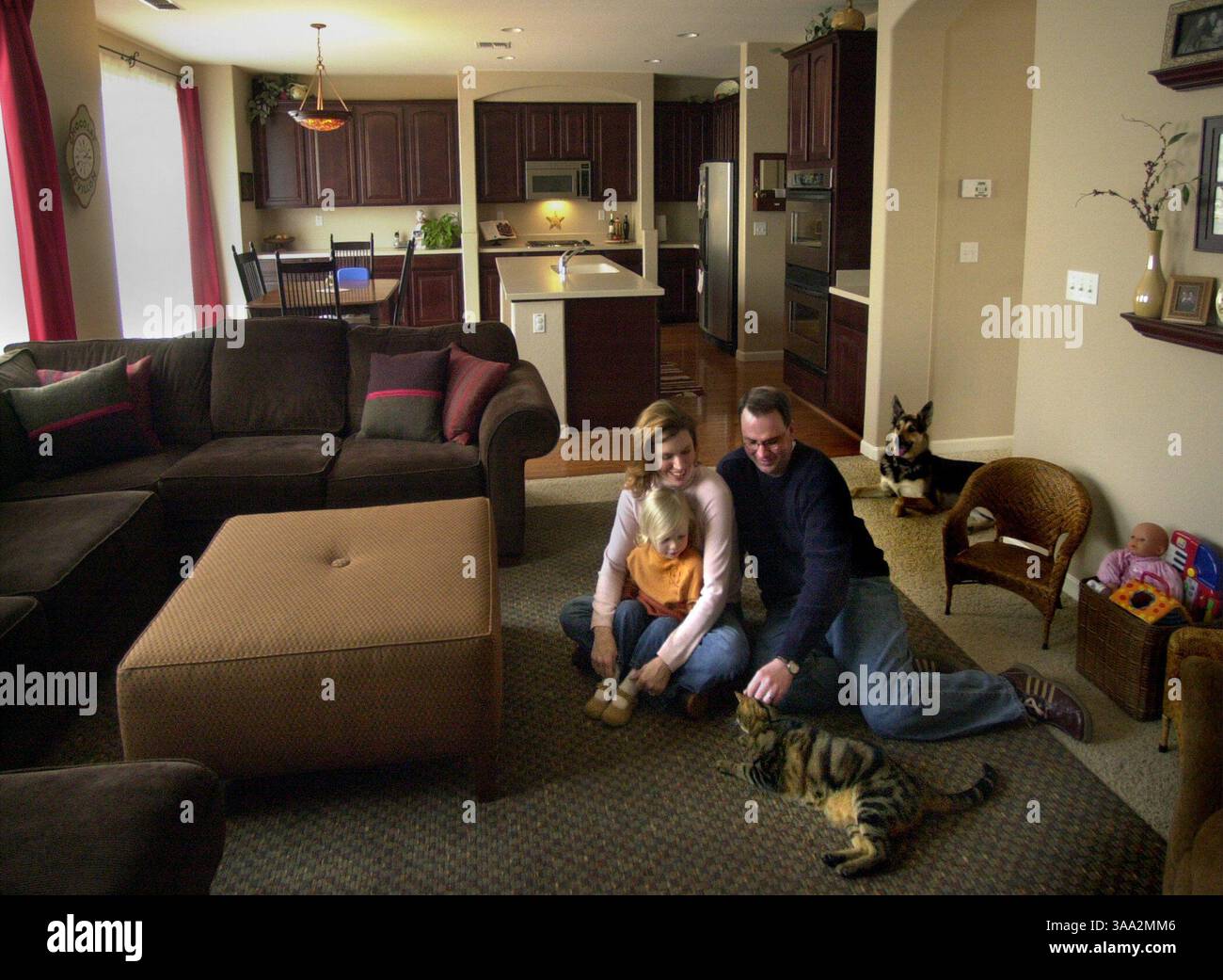 Mike and Kris Reed and daughter Ruthanne, 2 1/ 2, with Hans the dog and ...