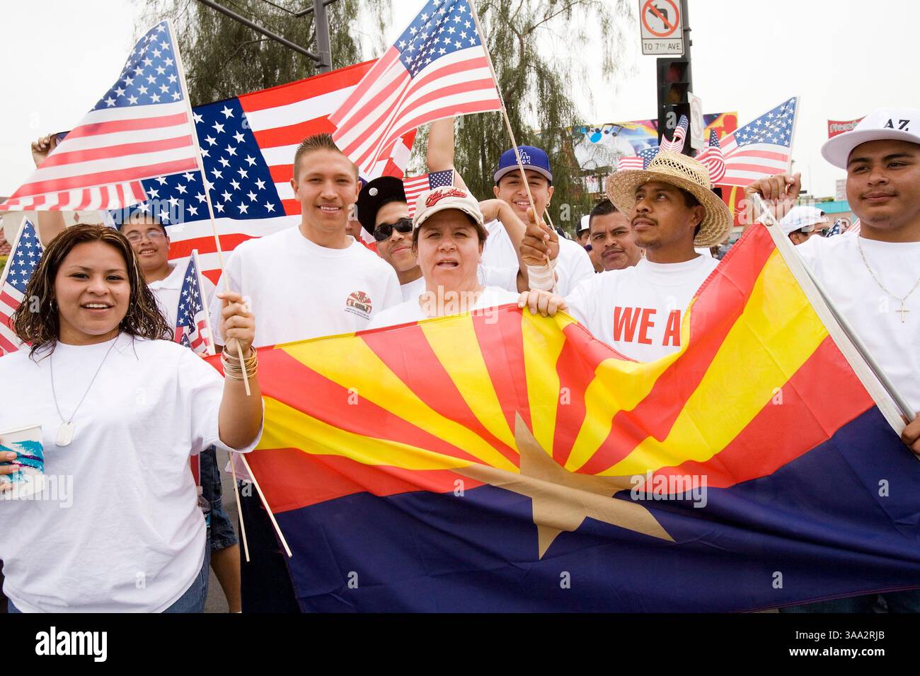 Apr 10, 2006; Phoenix, AZ, USA; Immigrants carry US and Arizona flags ...