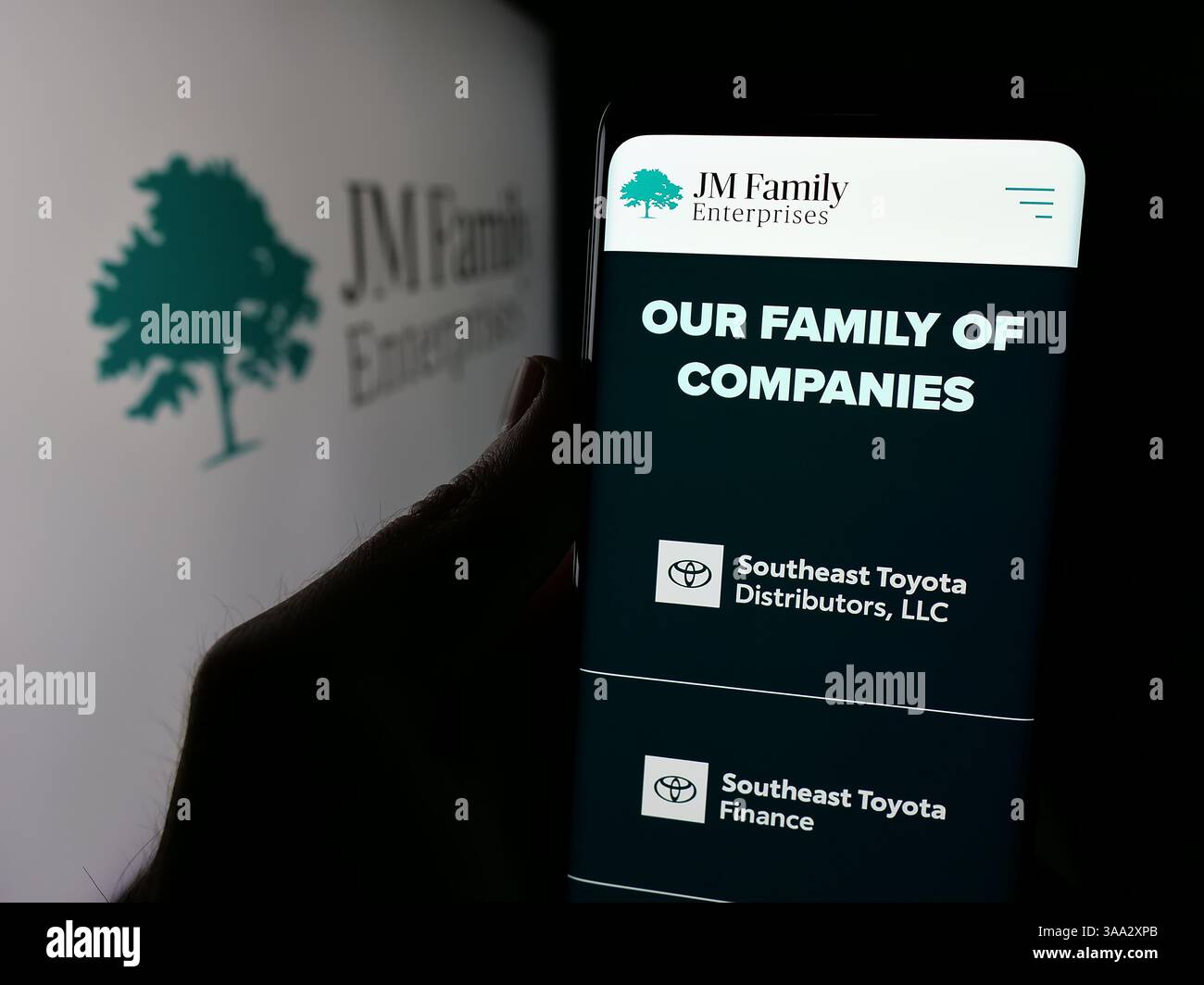 In this photo illustration, a person is holding a web page with the ...