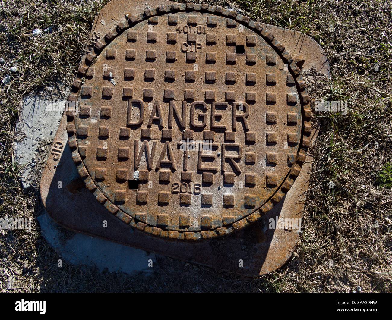 Danger water marked manhole visually highlights the need for caution ...