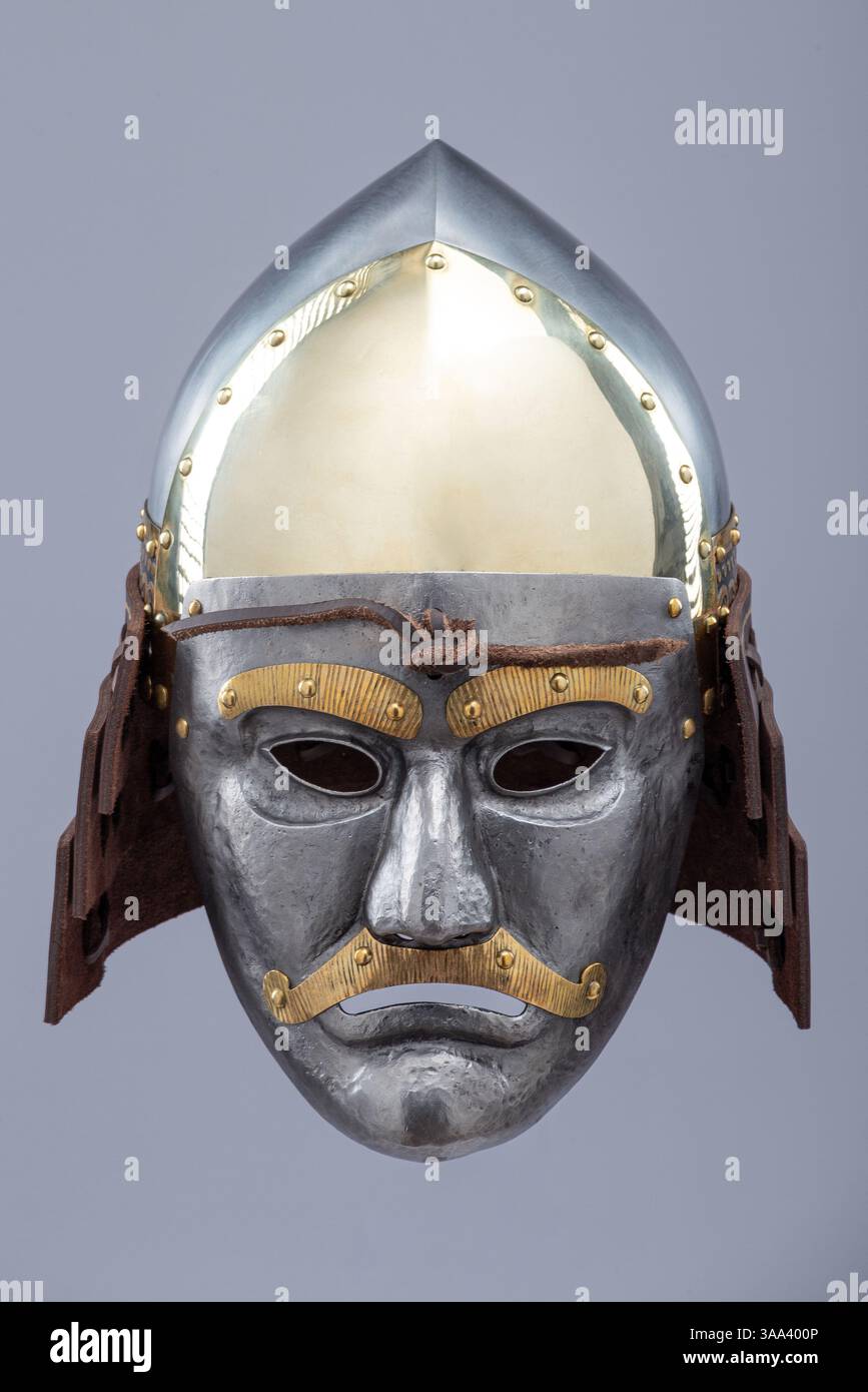 Historical metallic combat helmet with integrated face mask. Pointed ...