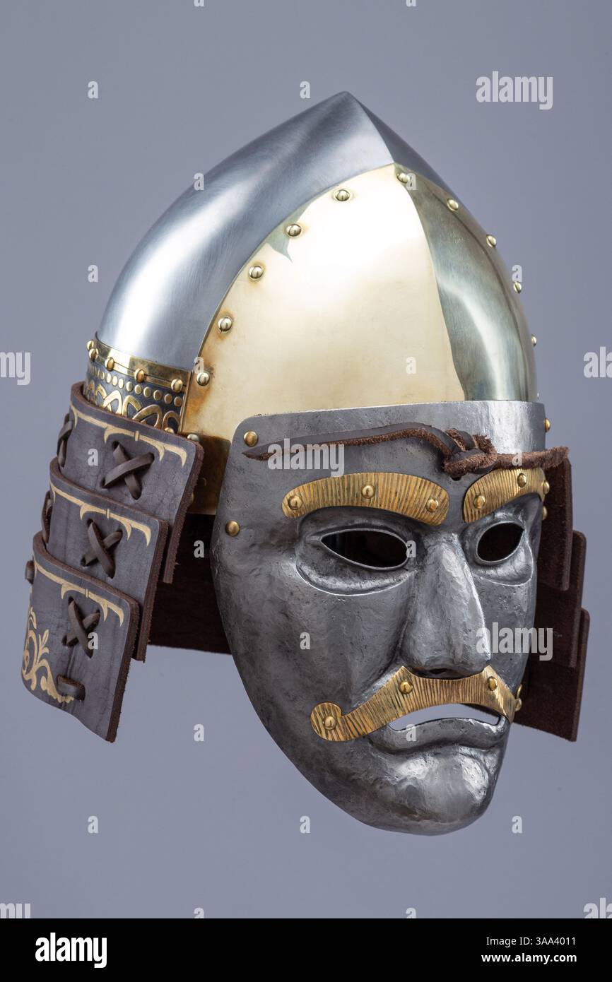 Historical metallic combat helmet with integrated face mask. Pointed ...