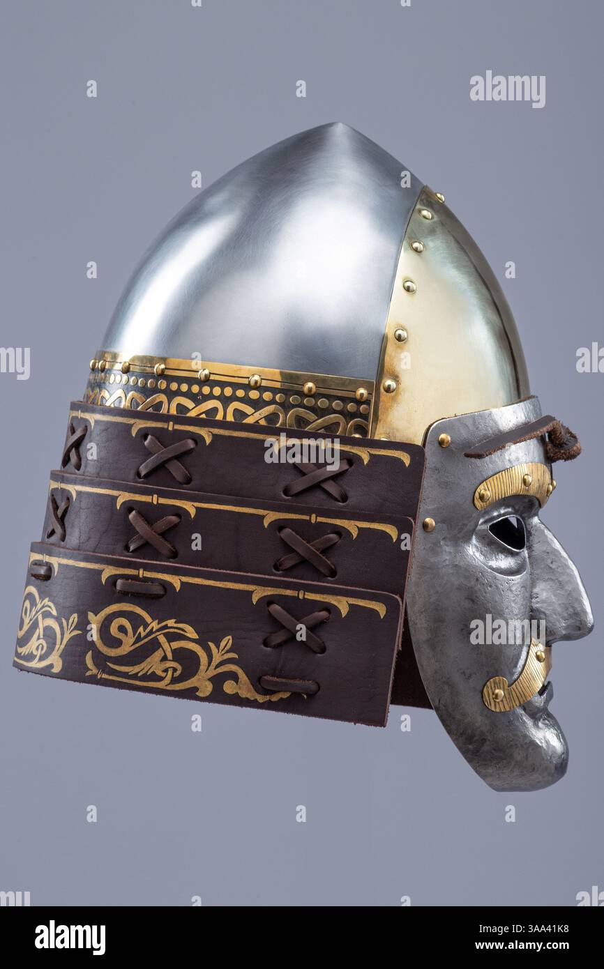 Historical metallic combat helmet with integrated face mask. Pointed ...