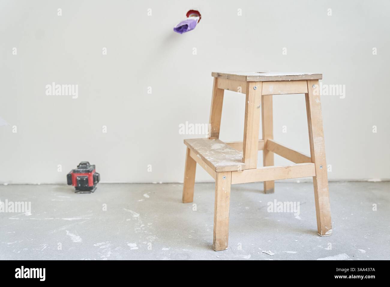 A wooden stand next to the laser equipment. The electrical outlet is ...