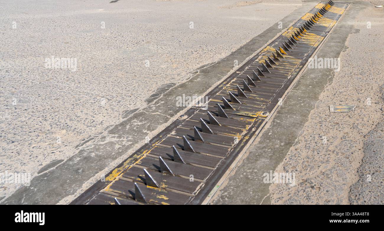 metal spikes in the asphalt, tire spike strip, spike barrier, one-way ...