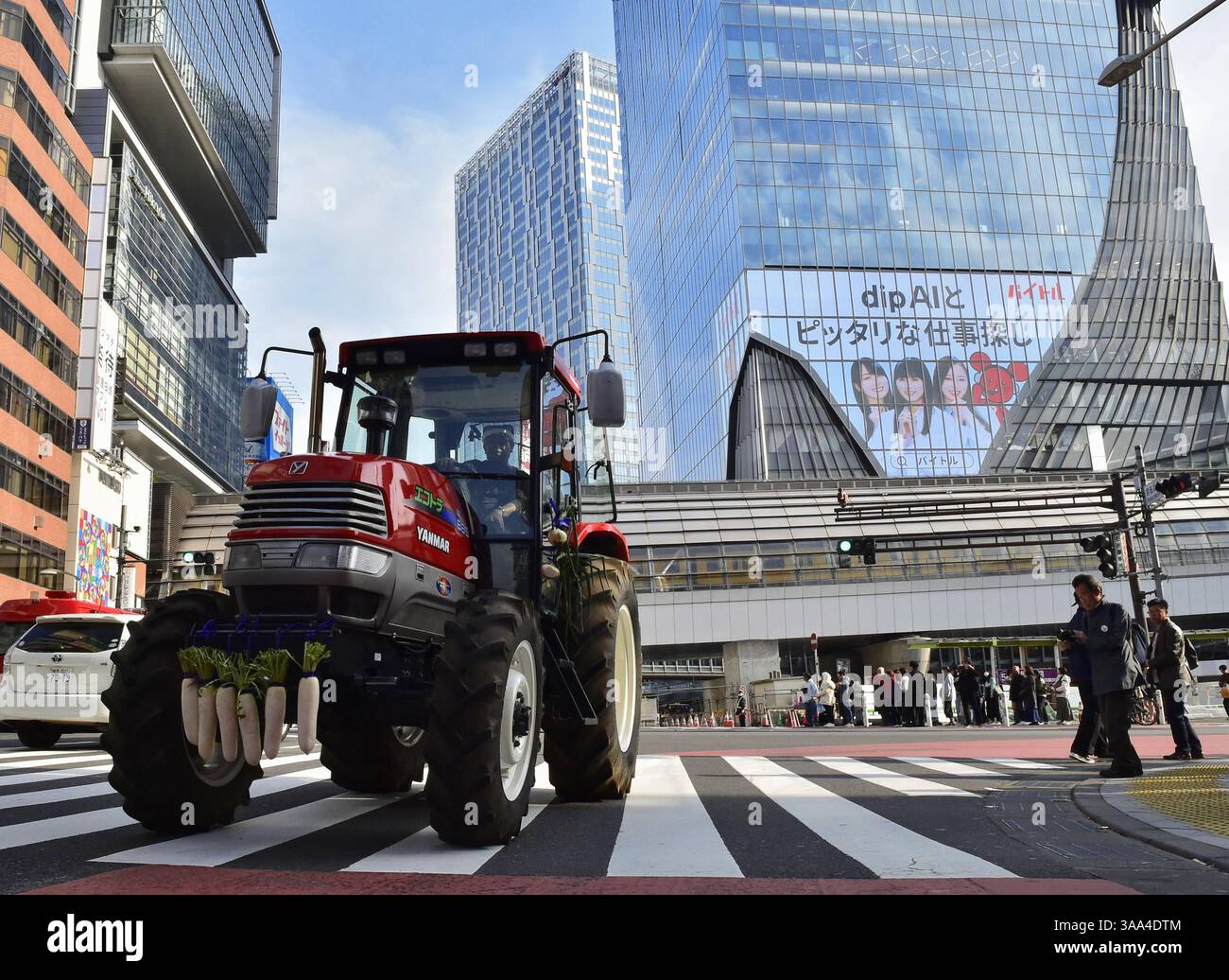 Farmers drive tractors on a public road in Tokyo's Shibuya Ward on ...