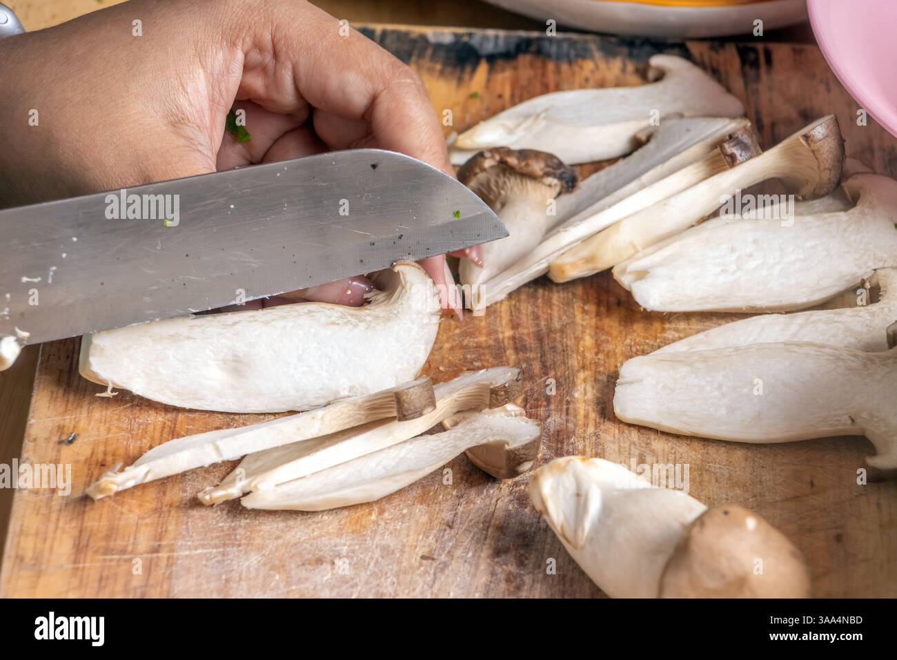 Slicing a mushroom on a kitchen cutting board Stock Photo - Alamy