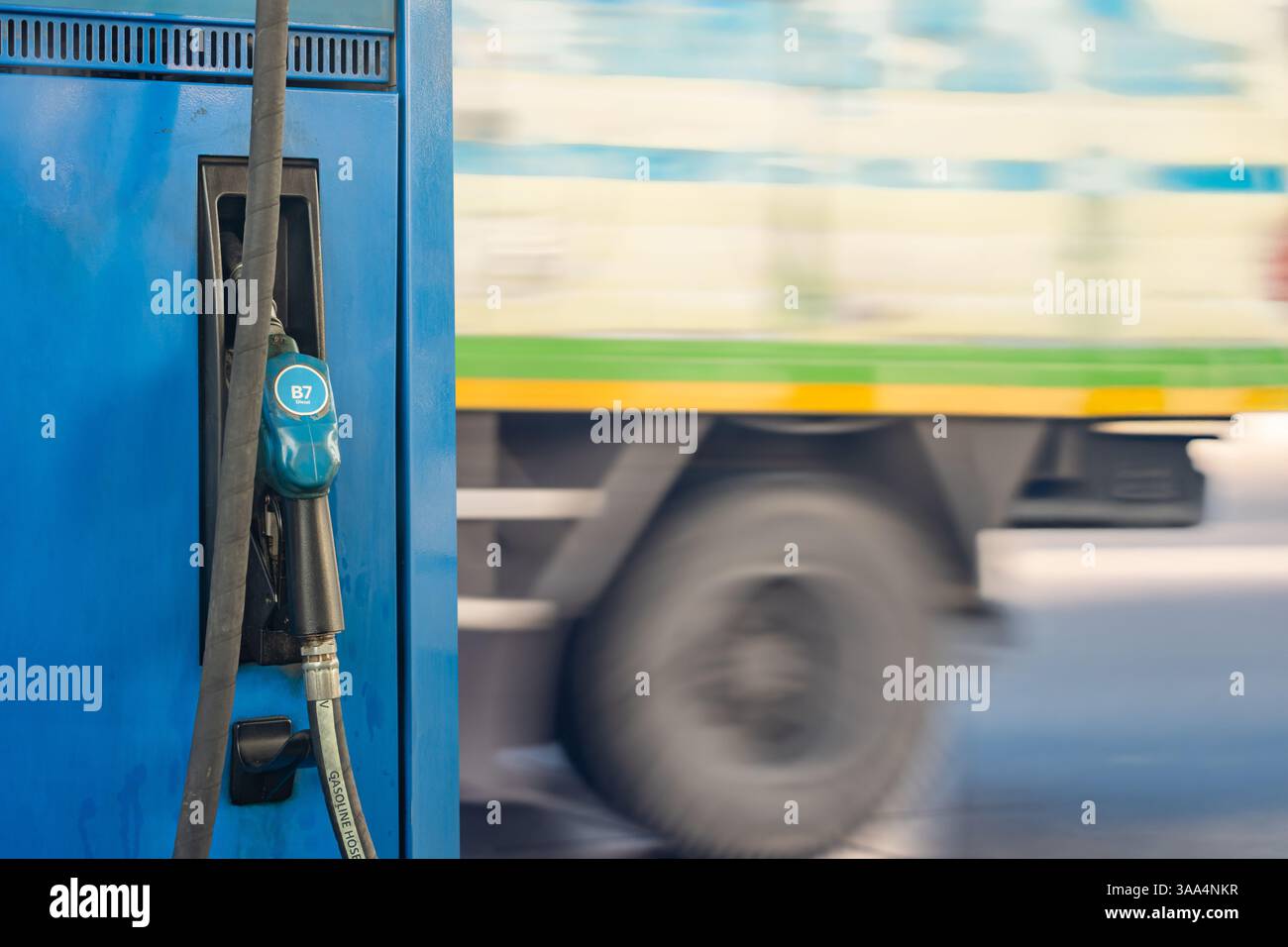 Fuel pump stand with pistol - nozzle, vehicles drive past Stock Photo ...