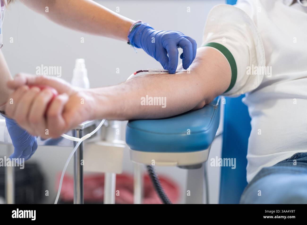 The hands of an anonymous nurse prepare the catheter for the patient's ...