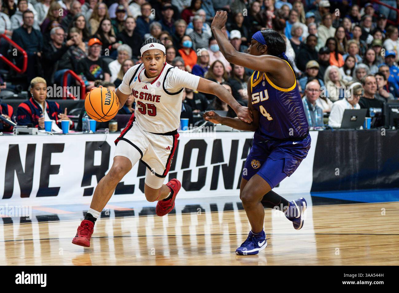 NC State Wolfpack guard Zoe Brooks (35) drives against LSU Tigers guard ...